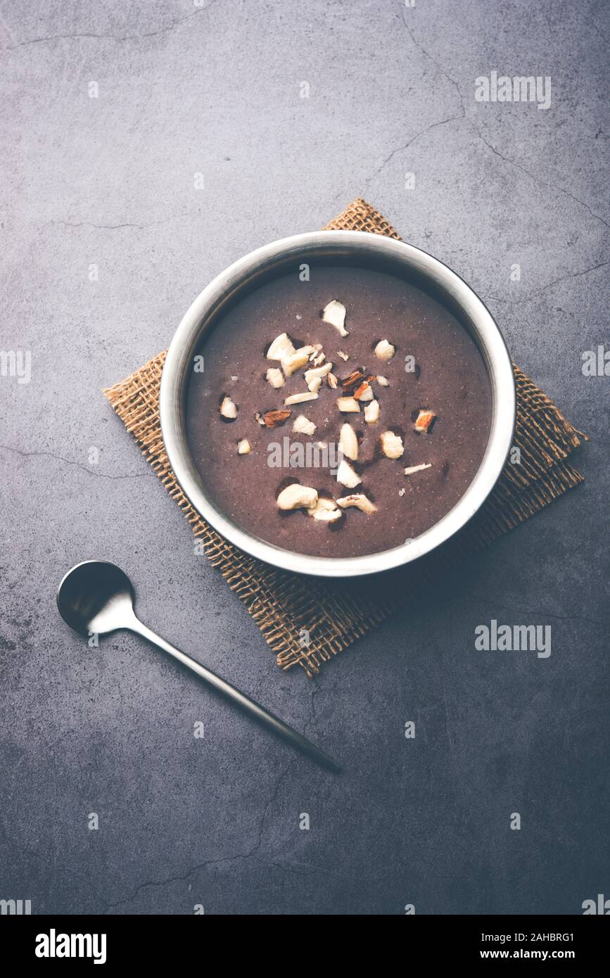Sweet Ragi Malt / Healthy Ragi Porridge in a bowl garnished with ...