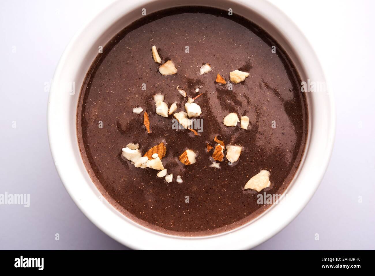 Sweet Ragi Malt / Healthy Ragi Porridge in a bowl garnished with ...