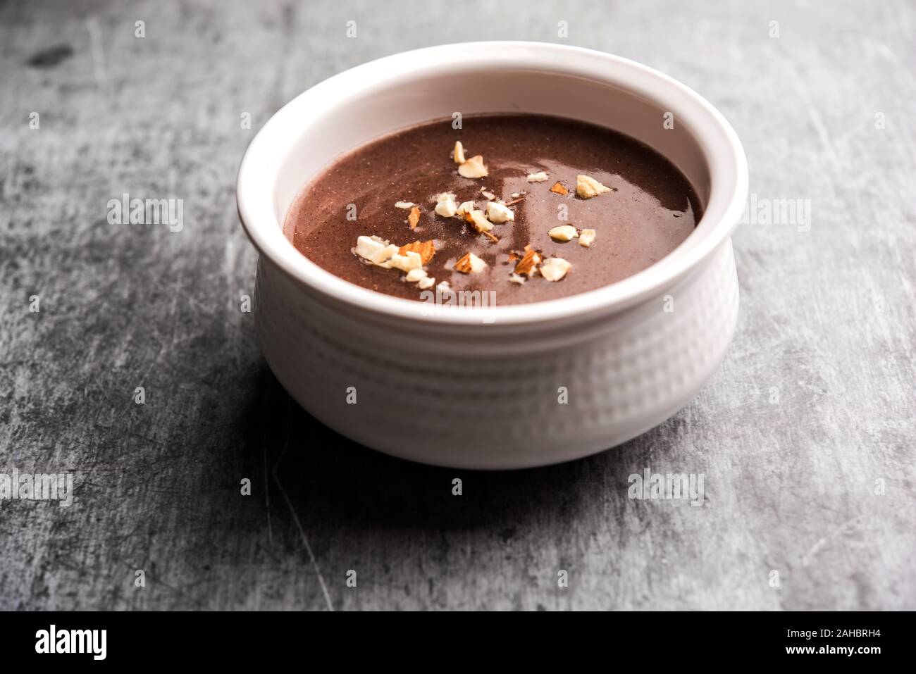 Sweet Ragi Malt / Healthy Ragi Porridge in a bowl garnished with ...