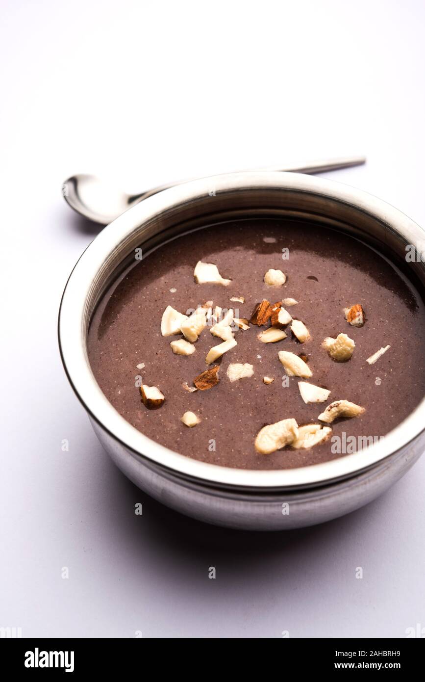 Sweet Ragi Malt / Healthy Ragi Porridge in a bowl garnished with ...