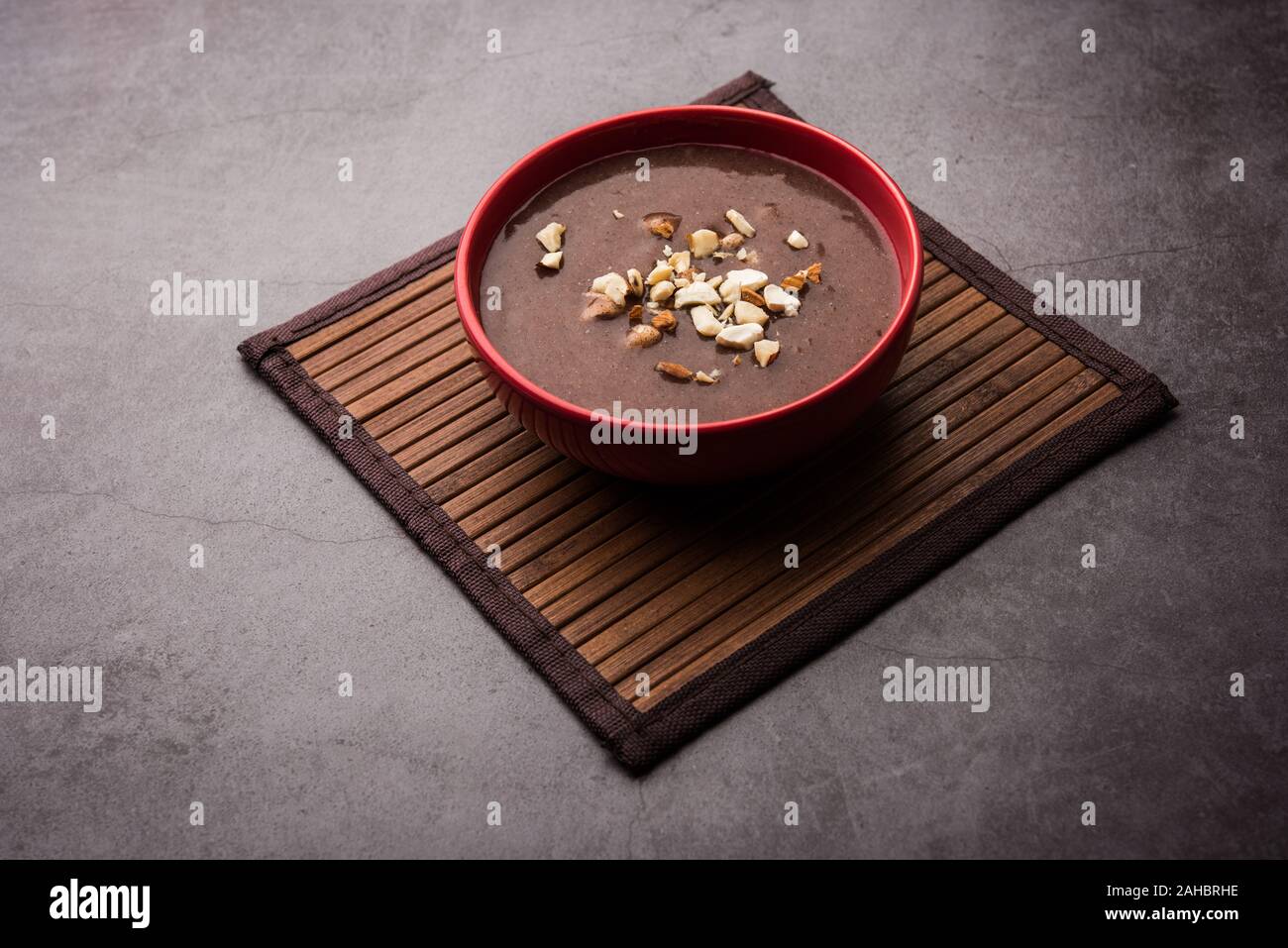 Sweet Ragi Malt / Healthy Ragi Porridge in a bowl garnished with ...
