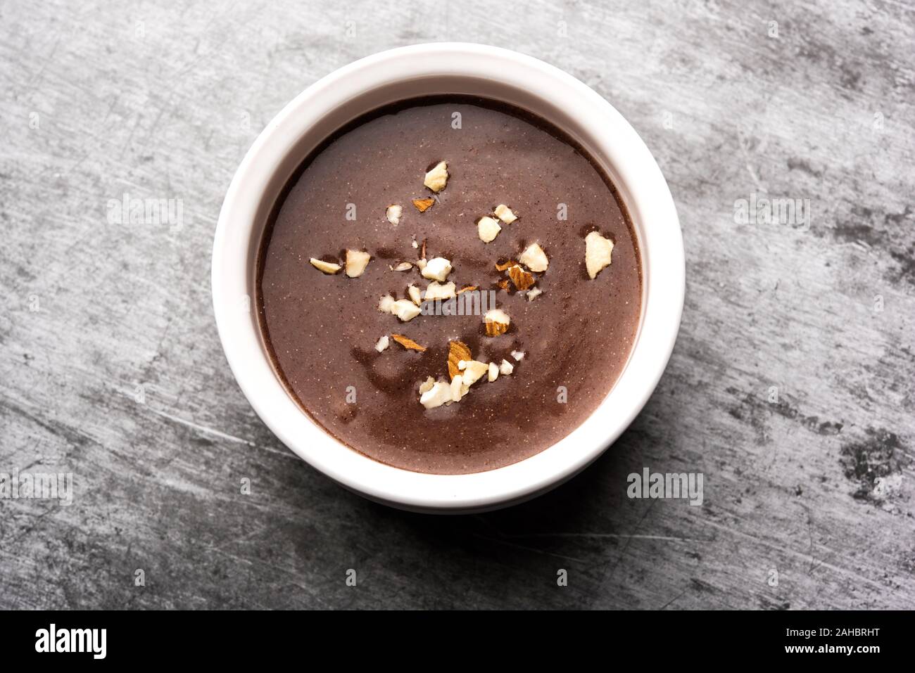 Sweet Ragi Malt / Healthy Ragi Porridge in a bowl garnished with ...