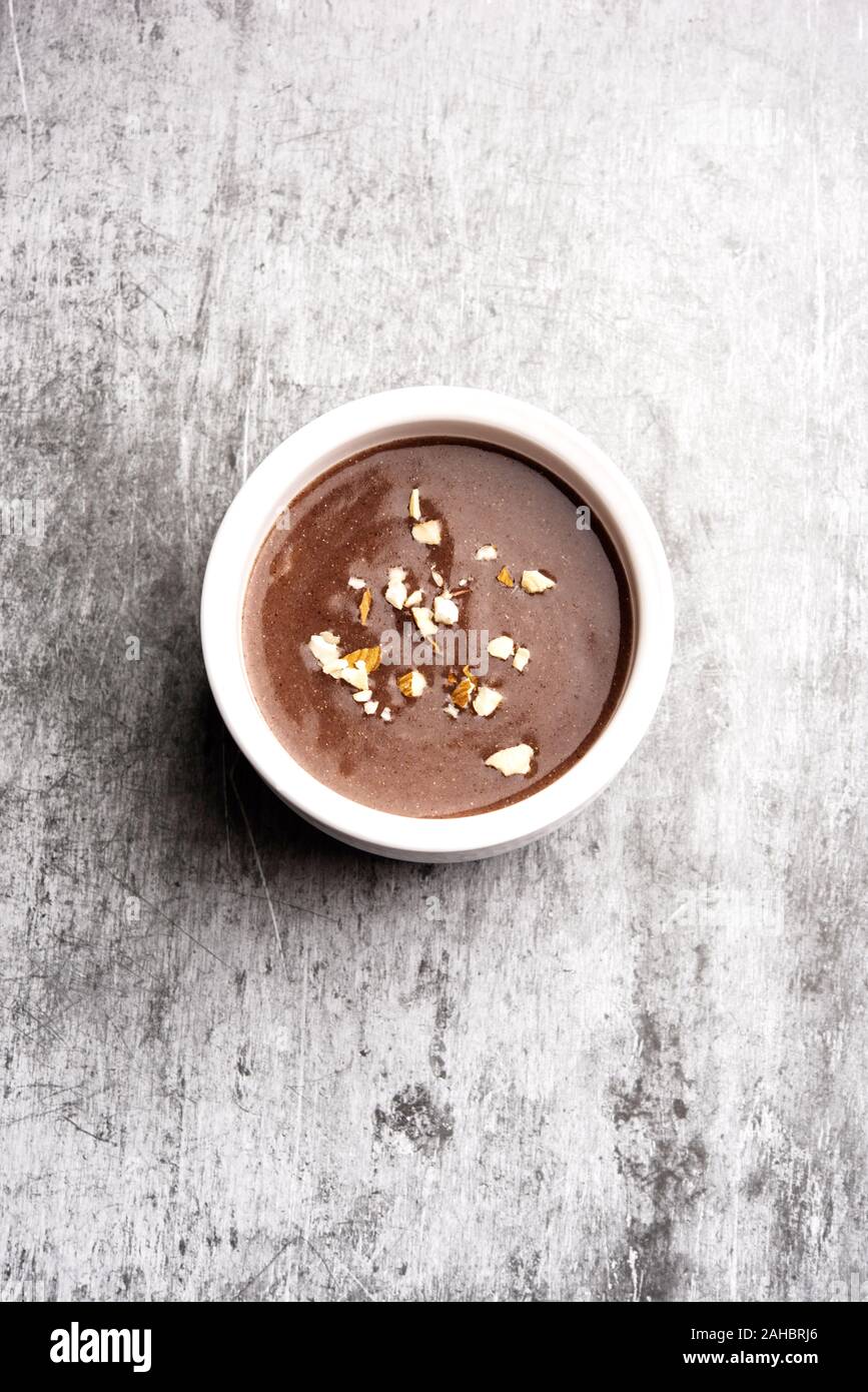 Sweet Ragi Malt / Healthy Ragi Porridge in a bowl garnished with ...