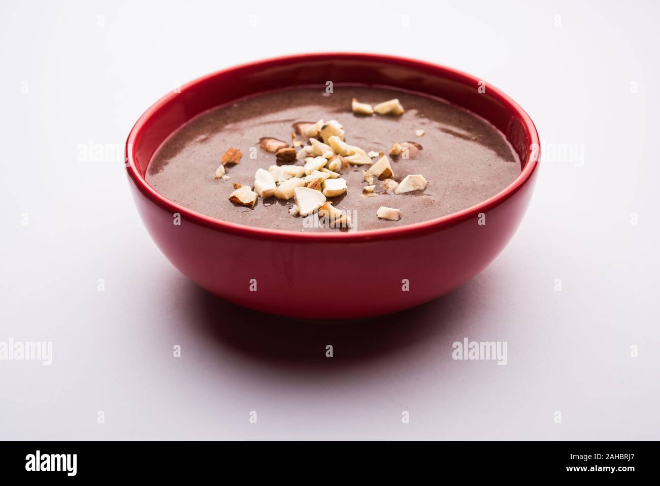 Sweet Ragi Malt / Healthy Ragi Porridge in a bowl garnished with ...