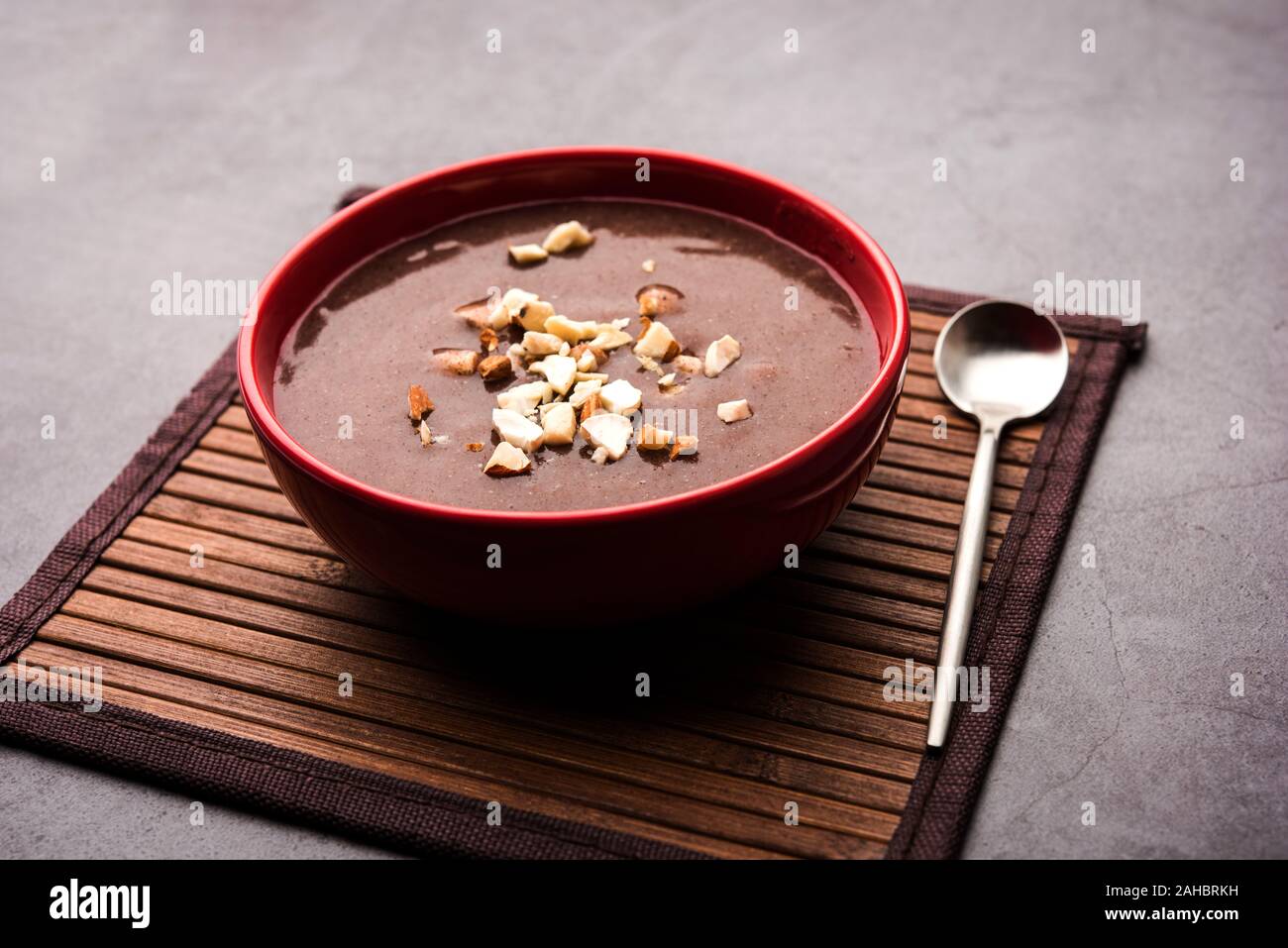 Sweet Ragi Malt / Healthy Ragi Porridge in a bowl garnished with ...