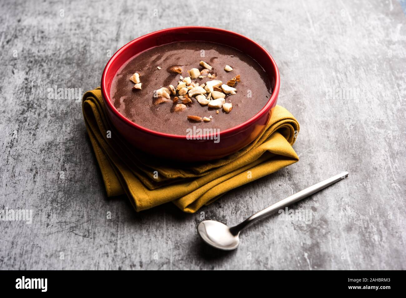 Sweet Ragi Malt / Healthy Ragi Porridge in a bowl garnished with ...