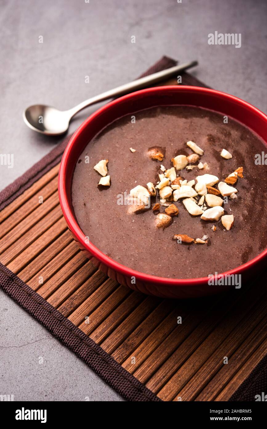 Sweet Ragi Malt / Healthy Ragi Porridge in a bowl garnished with ...