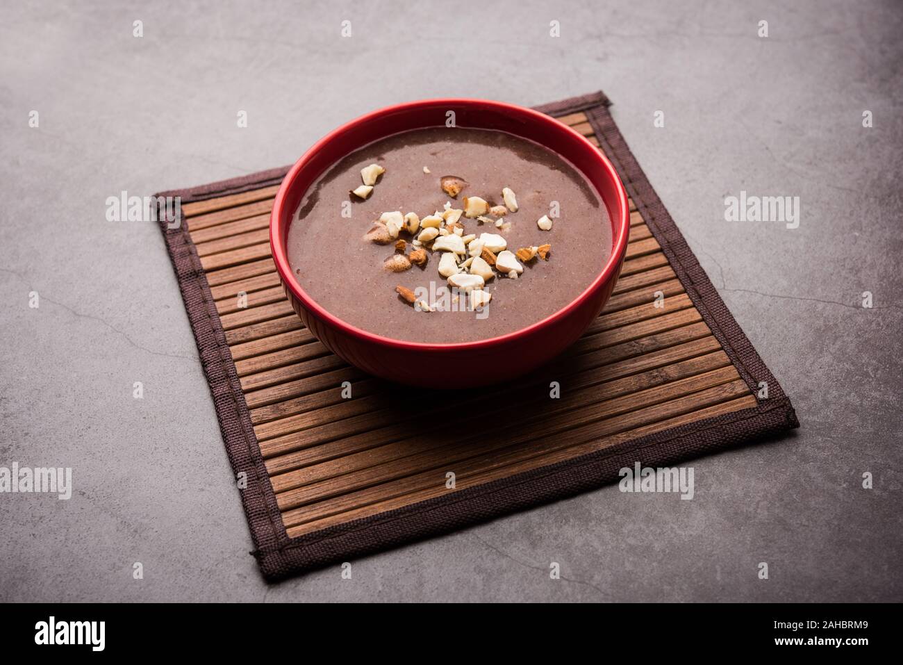 Sweet Ragi Malt / Healthy Ragi Porridge in a bowl garnished with ...