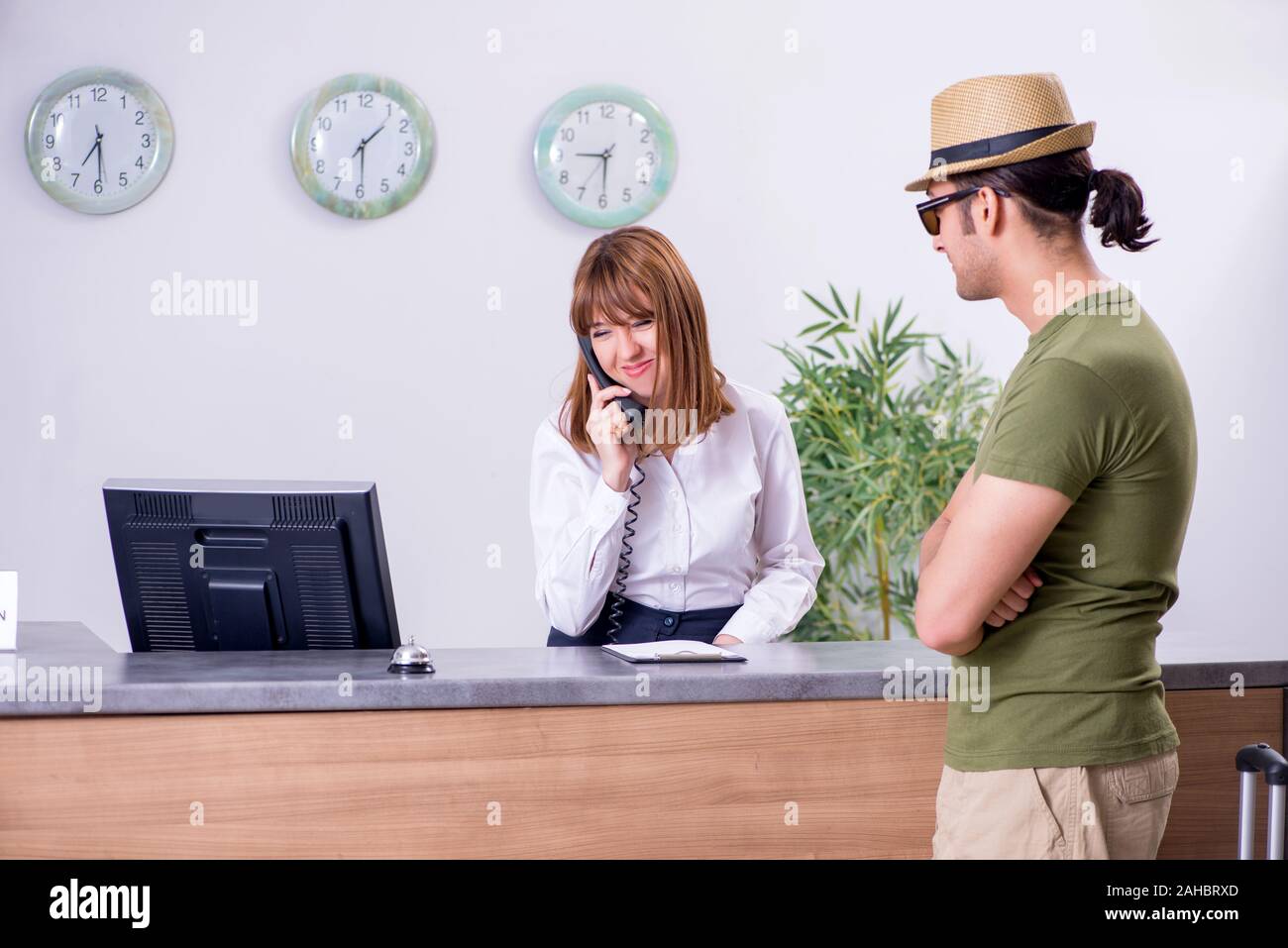 Businessman tourism talking telephone reception counter in hotel hi-res ...