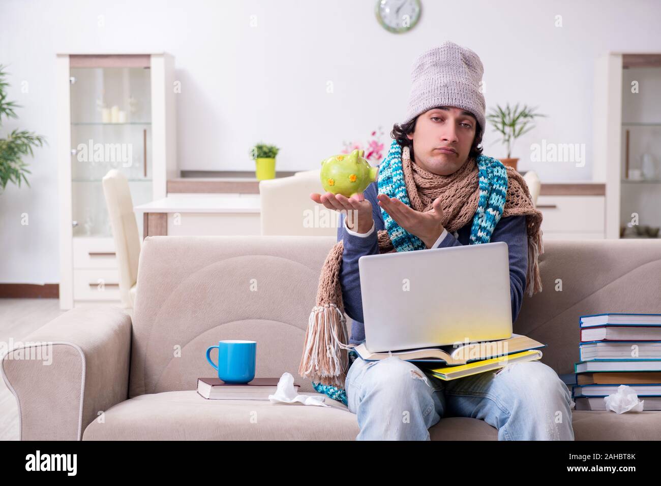 The sick male student suffering at home Stock Photo - Alamy