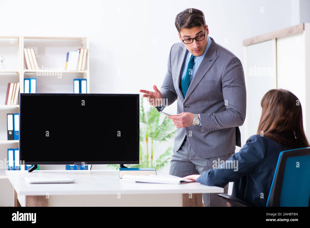 The young employee making presentation to his female boss Stock Photo ...