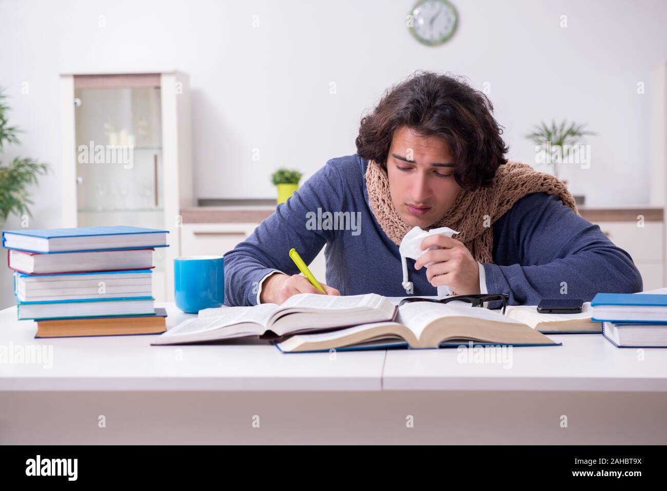 The sick male student suffering at home Stock Photo - Alamy