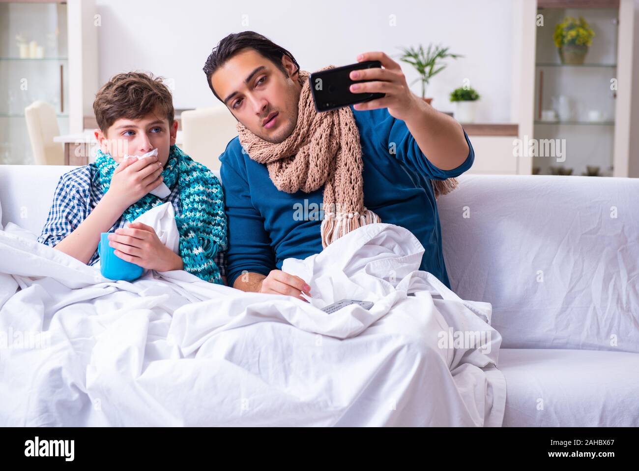 The young father caring for sick son Stock Photo - Alamy