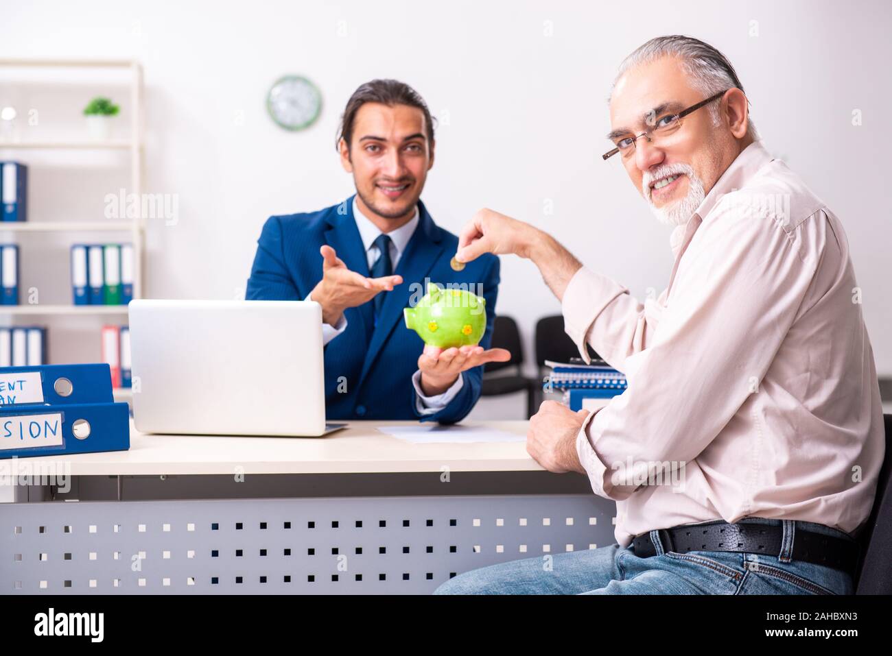 The financial advisor giving retirement advice to old man Stock Photo ...