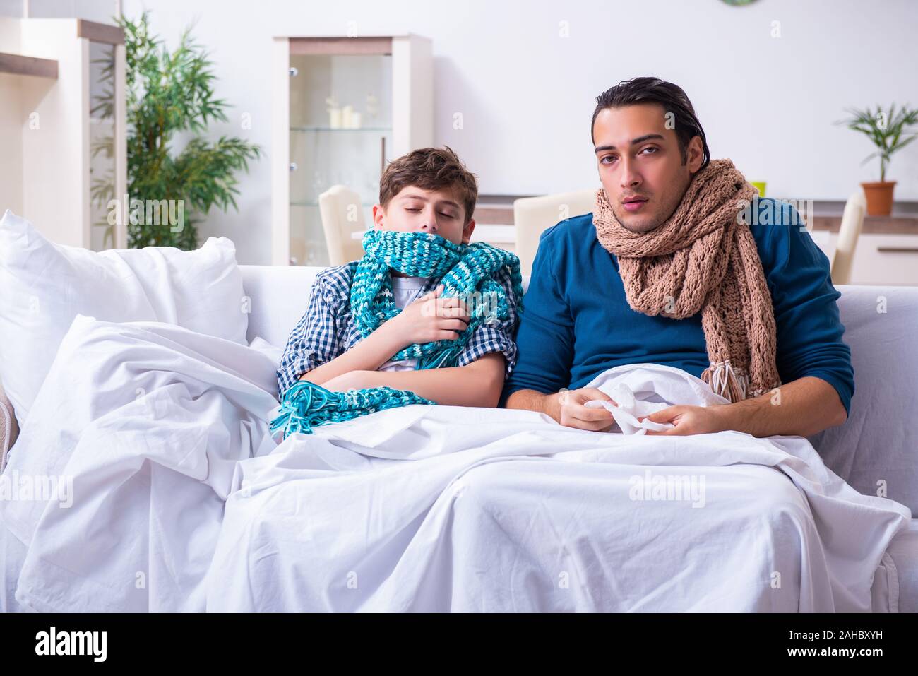 The young father caring for sick son Stock Photo - Alamy