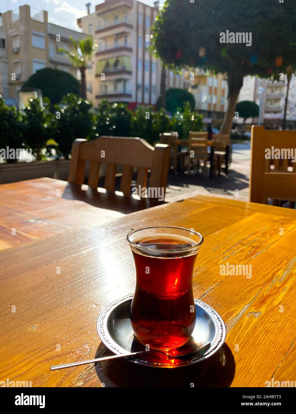 On the table is a Turkish cup with black tea, residential buildings ...