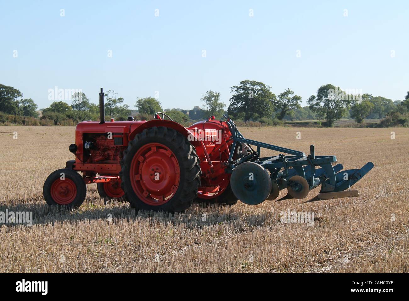 A Vintage Tractor and Plough in a Farming Field Stock Photo - Alamy