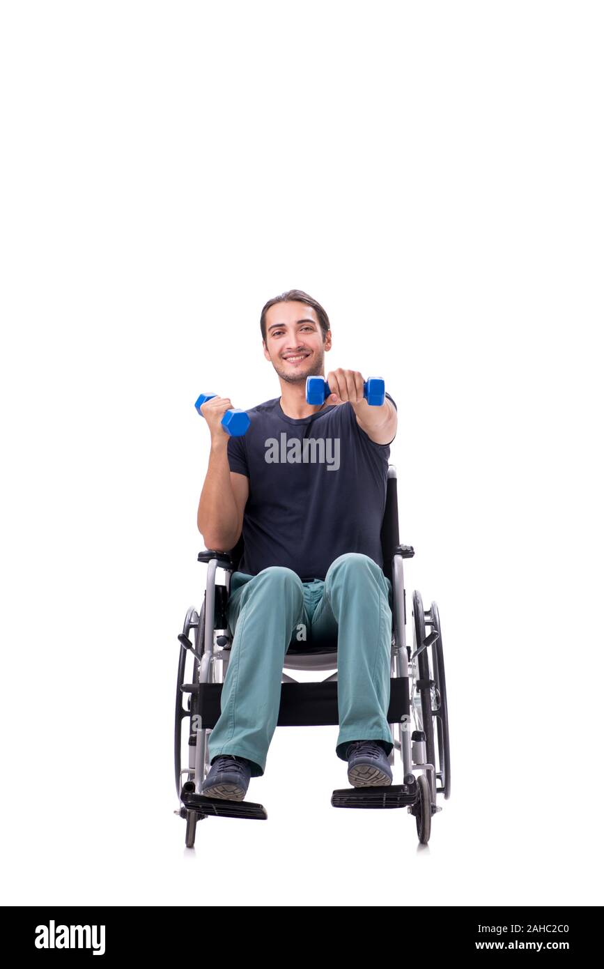 The young disabled man doing physical exercises isolated on white Stock ...