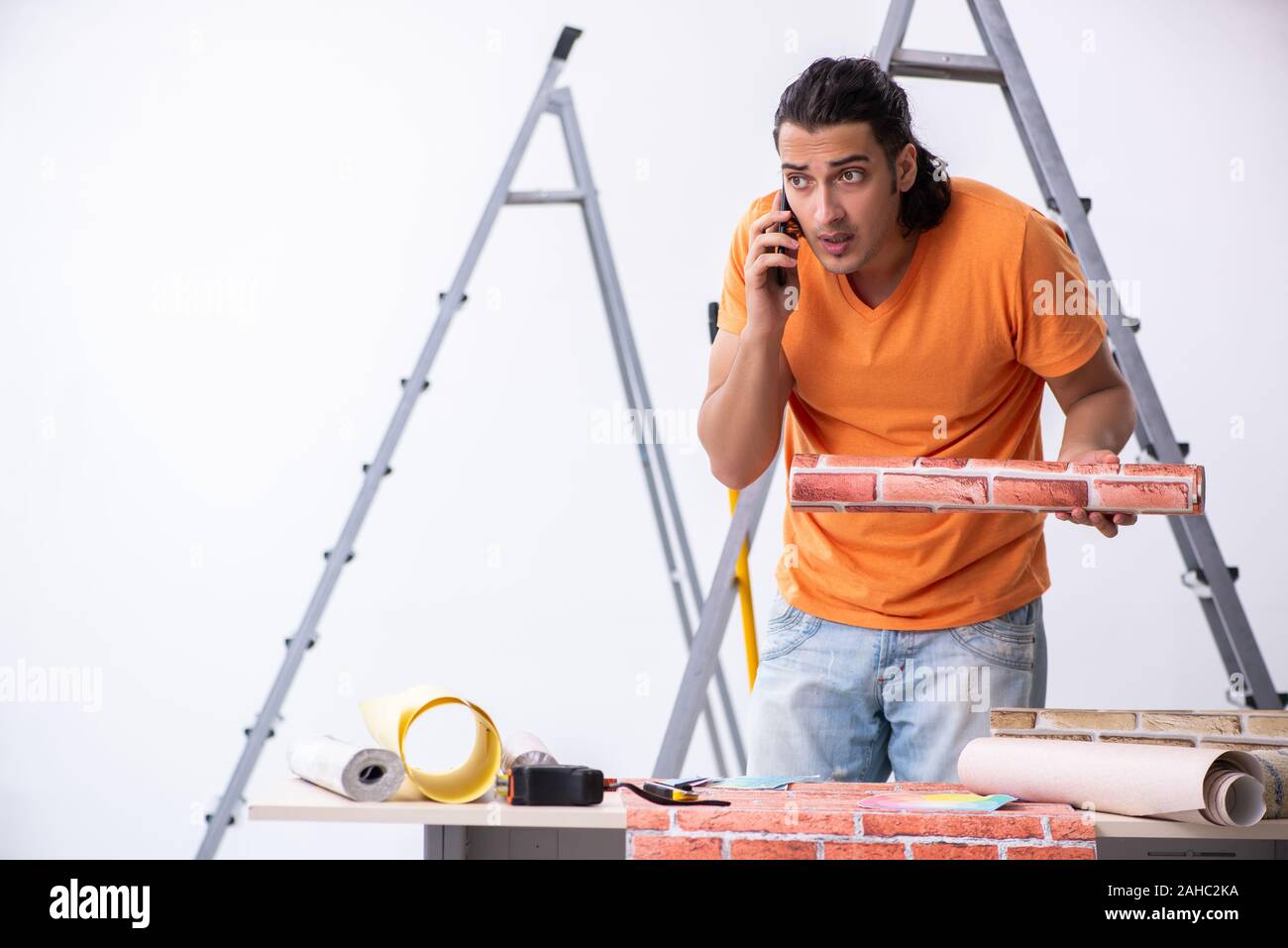 The young man contractor doing renovation at home Stock Photo - Alamy