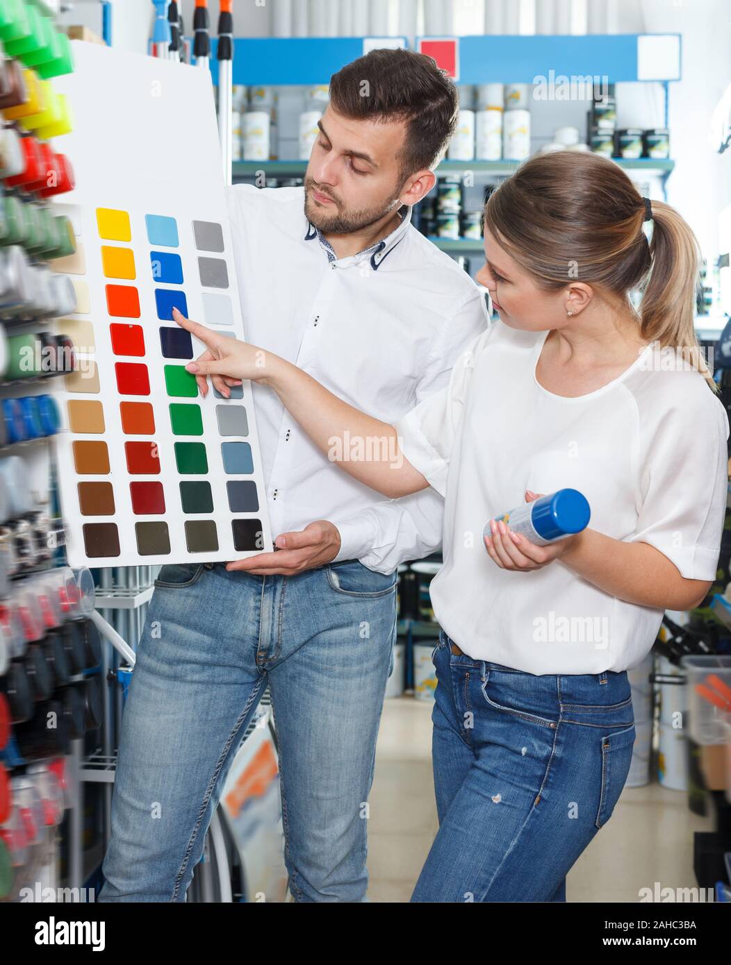 Friendly man and woman standing with tools using palette scheme in ...
