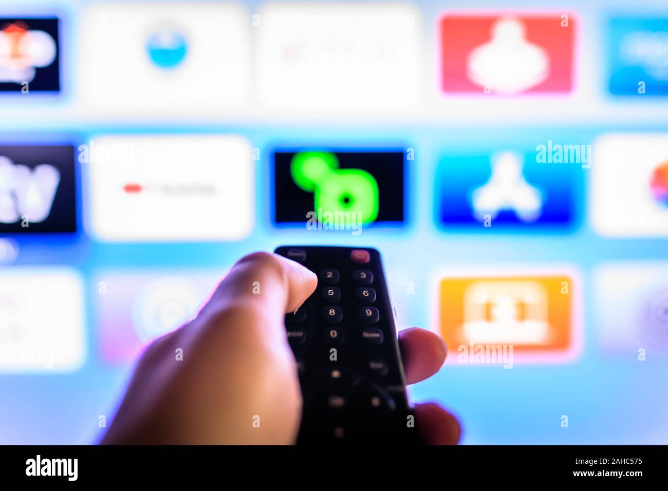 Hand holding satellite remote control hi-res stock photography and ...