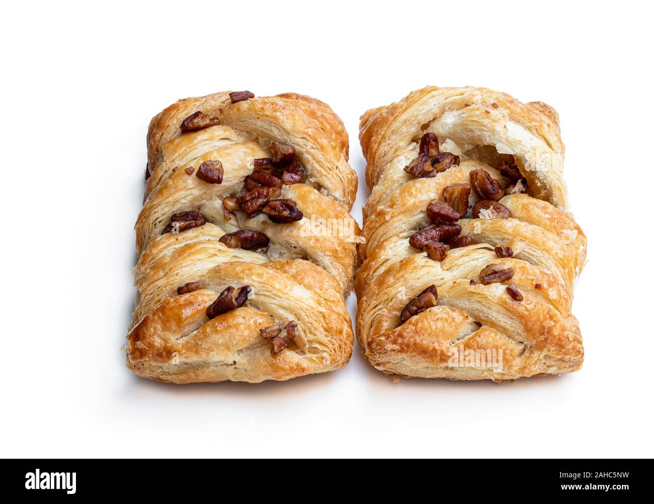 Flaky pastry filled with maple syrup and topped with pecan isolated on ...