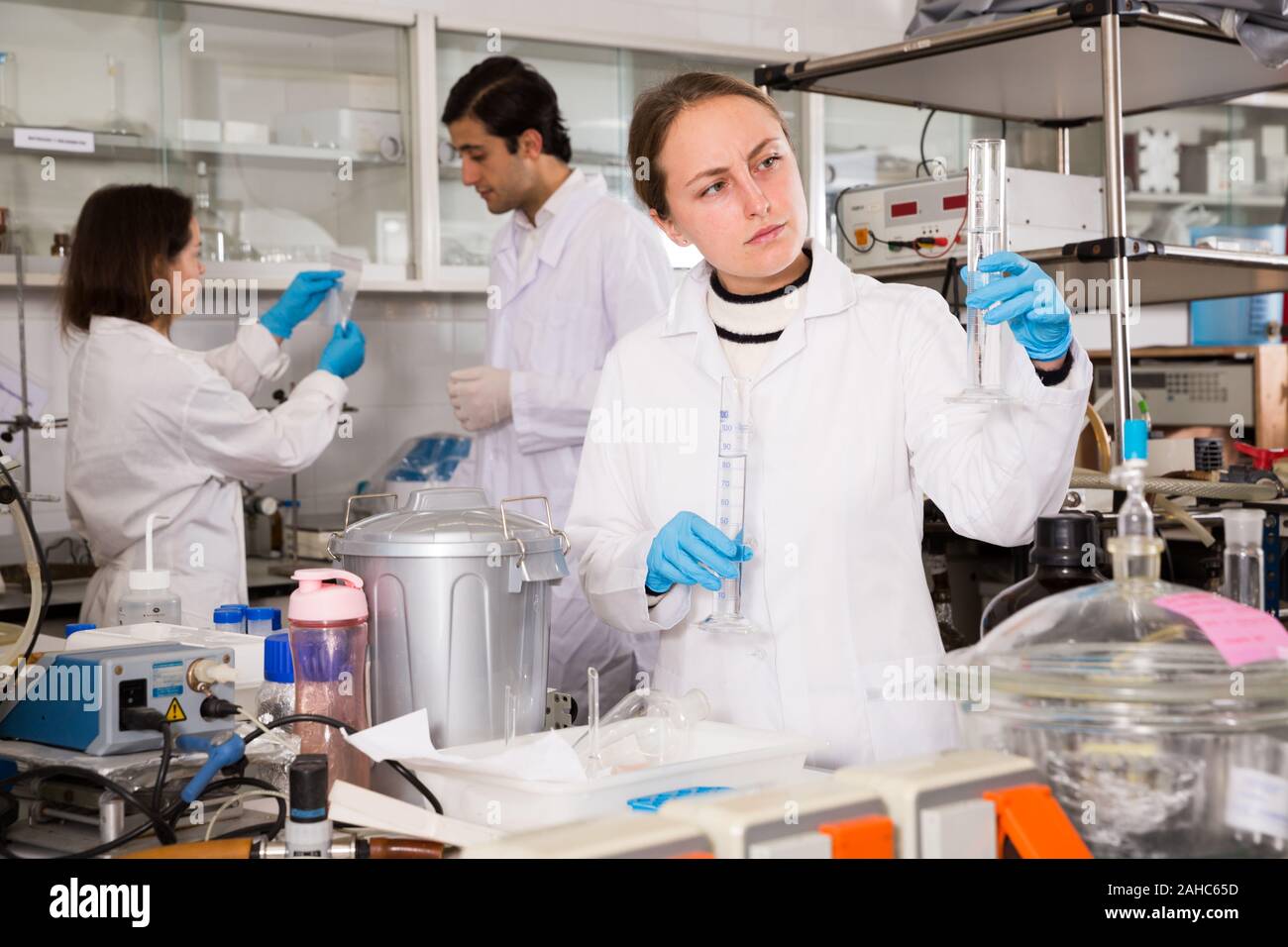 Female student performing experiments in university laboratory ...