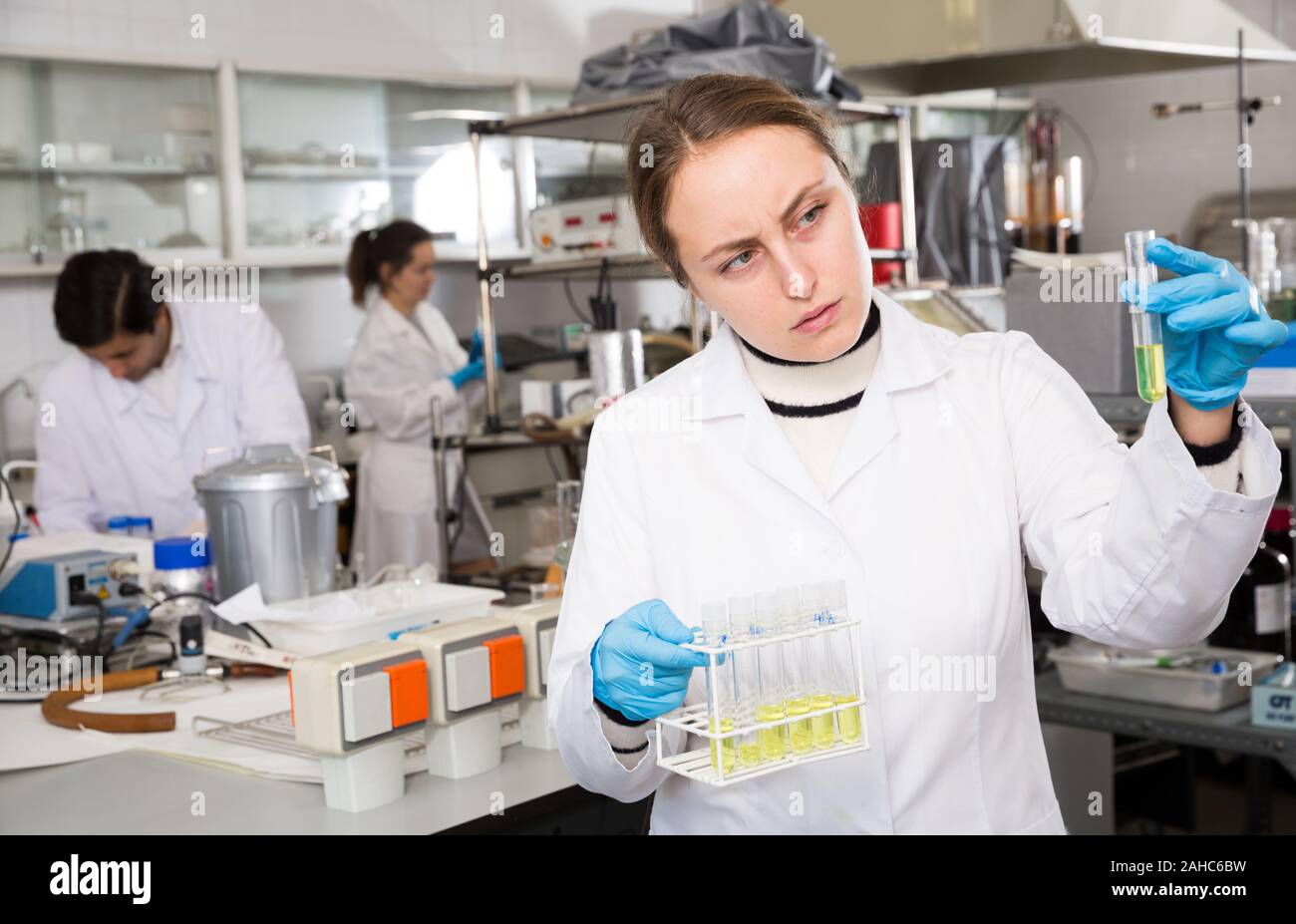 Female student performing experiments in university laboratory ...