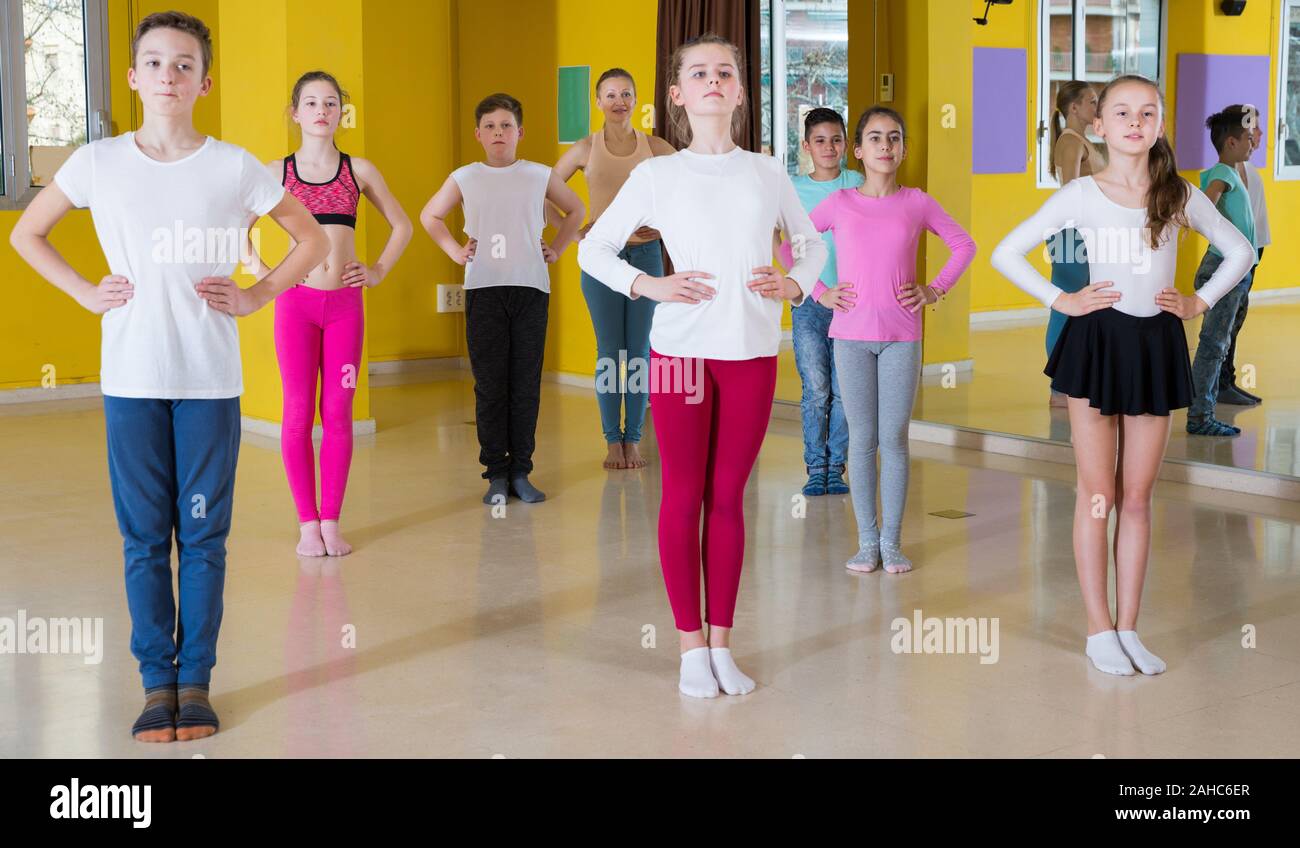 Teenagers dancers practicing dance routine with female choreographer in ...