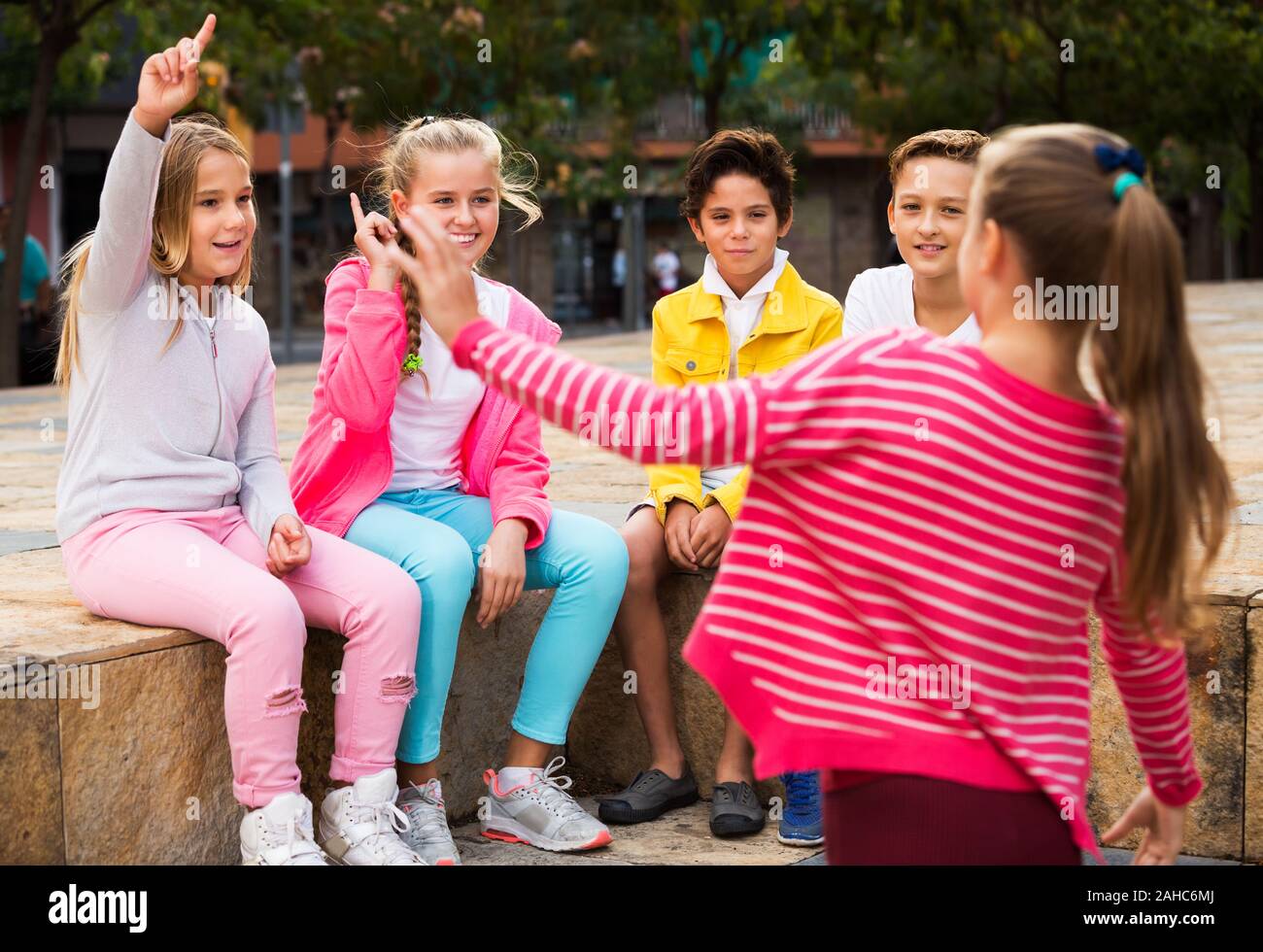 Small children talking on playground hi-res stock photography and ...
