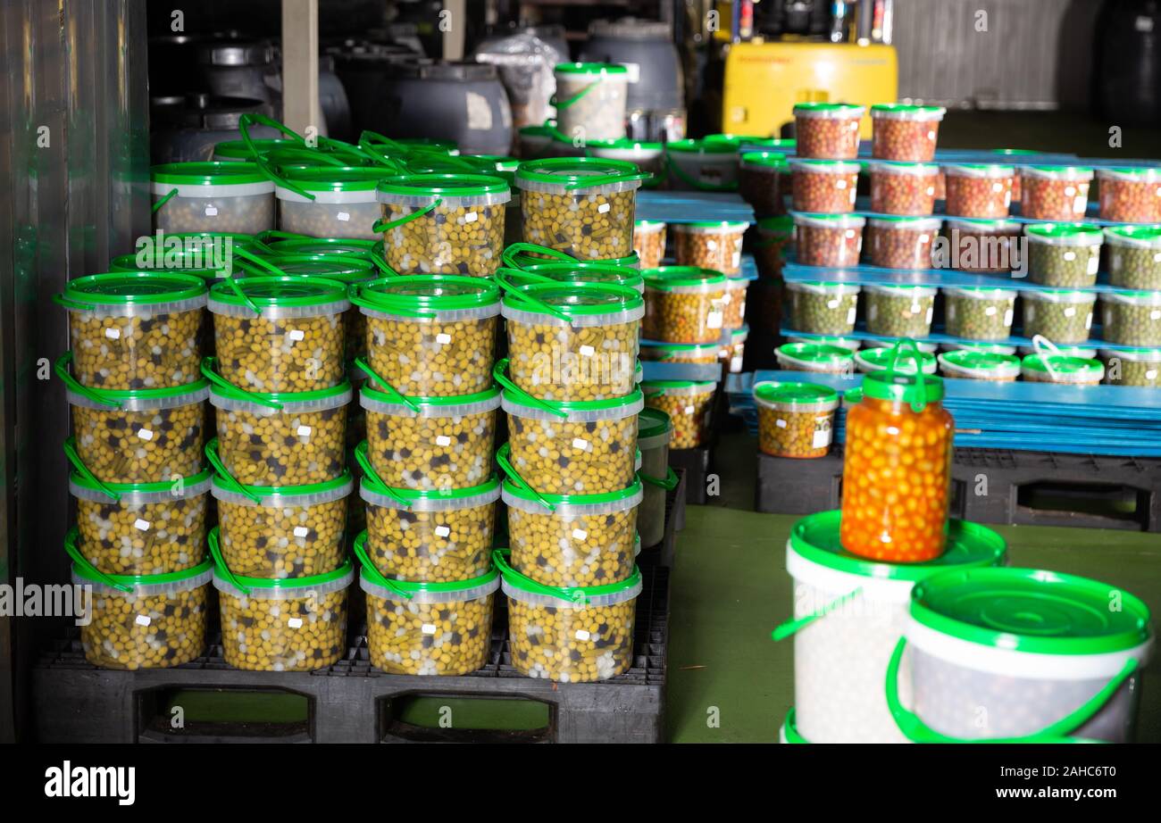 Interior of warehouse on food producing factory with stacked plastic ...