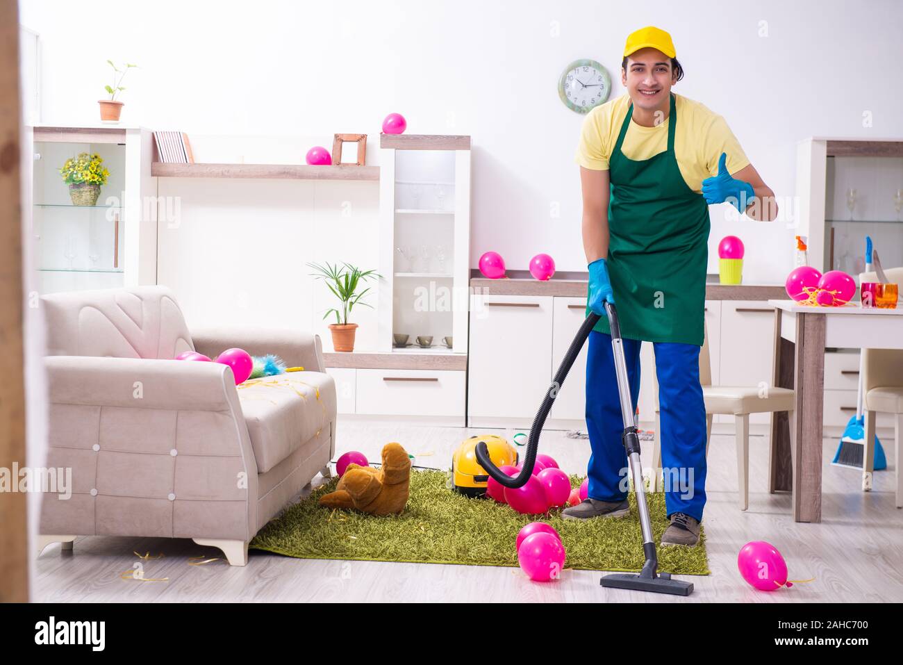 Young male contractor doing housework after party hi-res stock ...