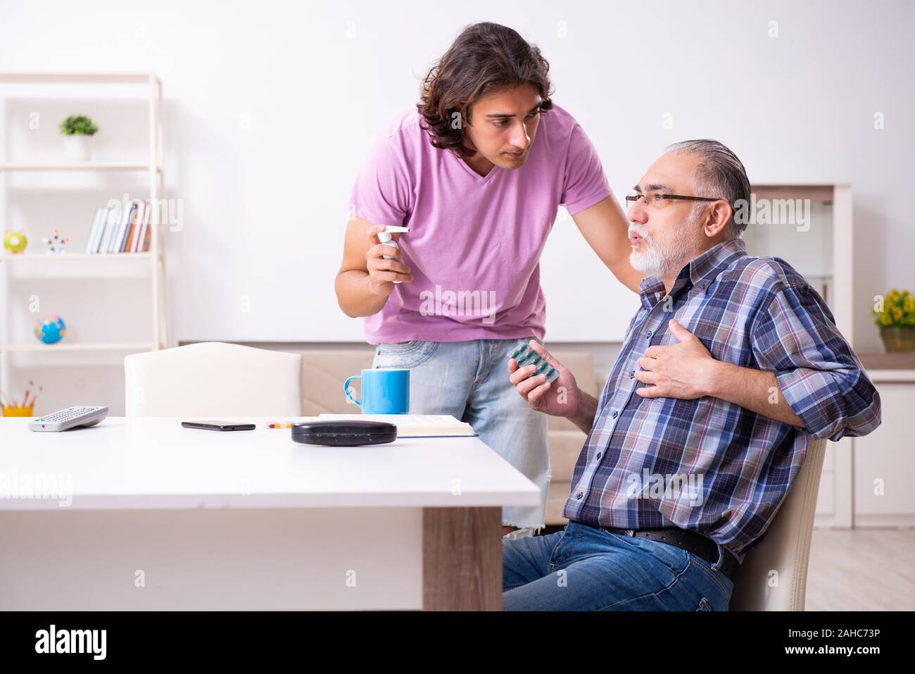 The young student and his old grandpa at home Stock Photo - Alamy