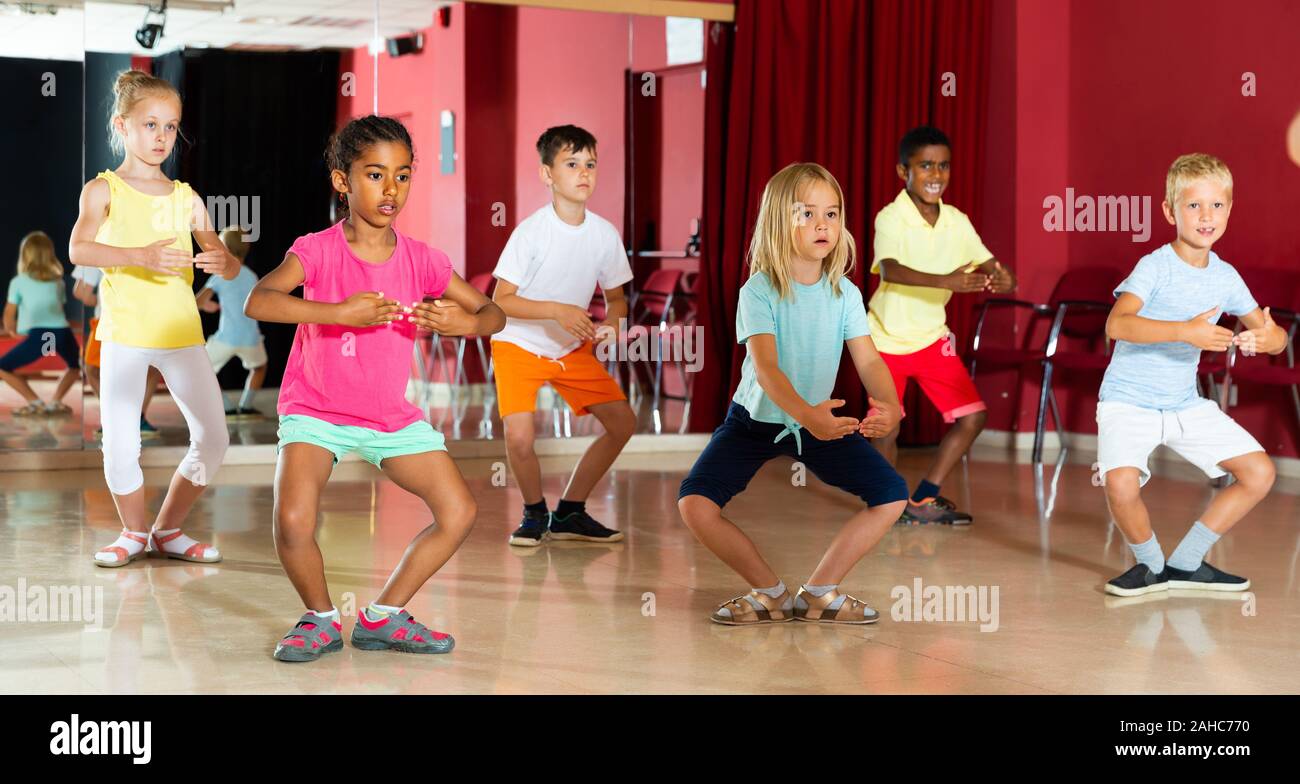 Nice children primary school age rehearsing movements of ballet dance ...