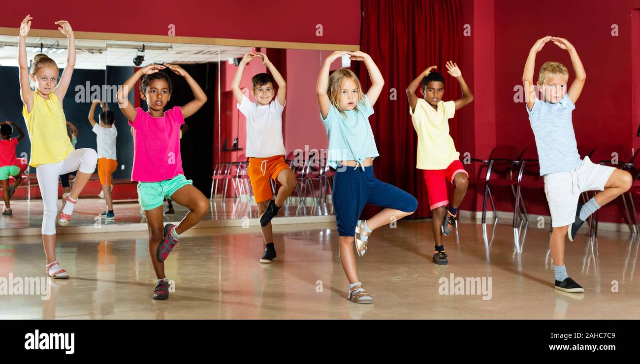 Group of positive childrens trying balance movements of ballet in ...