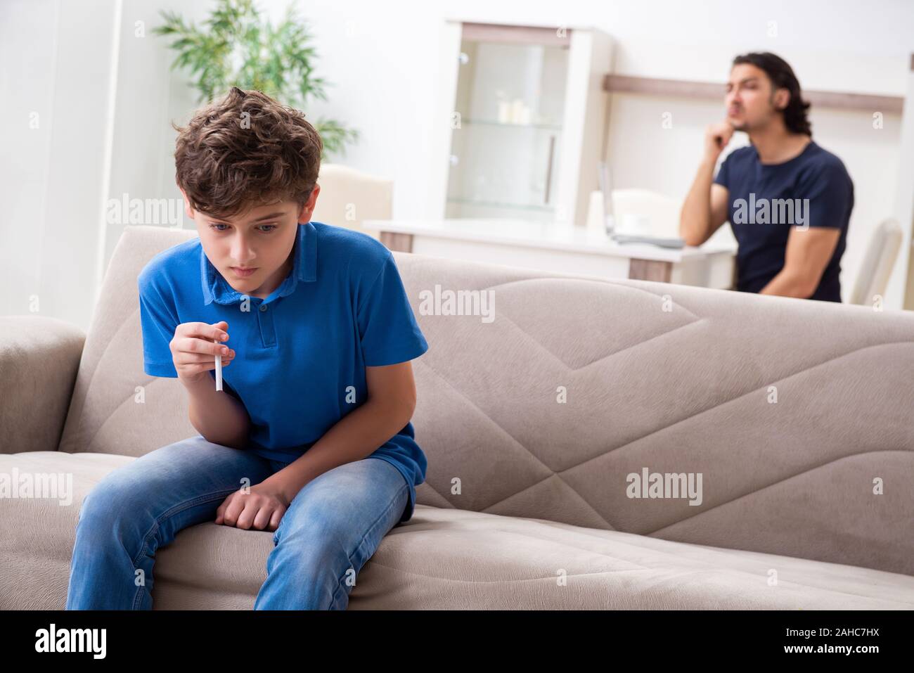 The concept of underage smoking with young boy and family Stock Photo ...