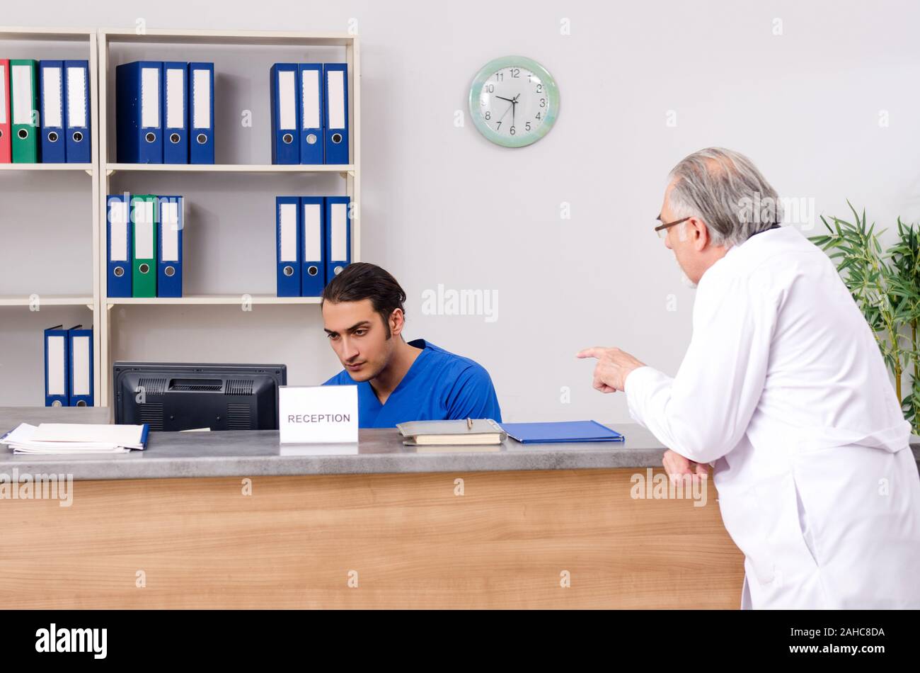Doctors talking at the reception in hospital Stock Photo - Alamy