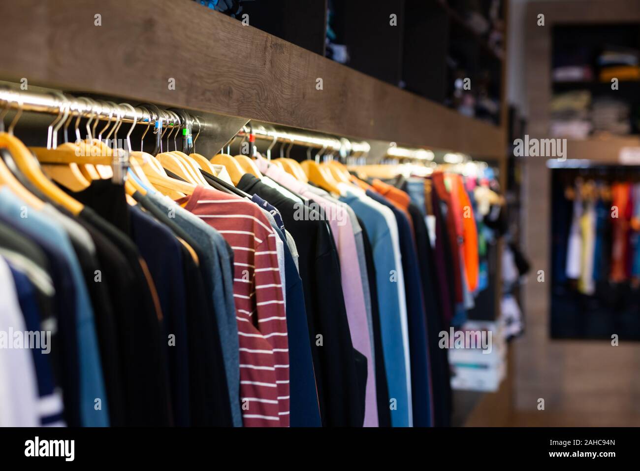 Assortment of summer and autumn clothing in modern garment store ...