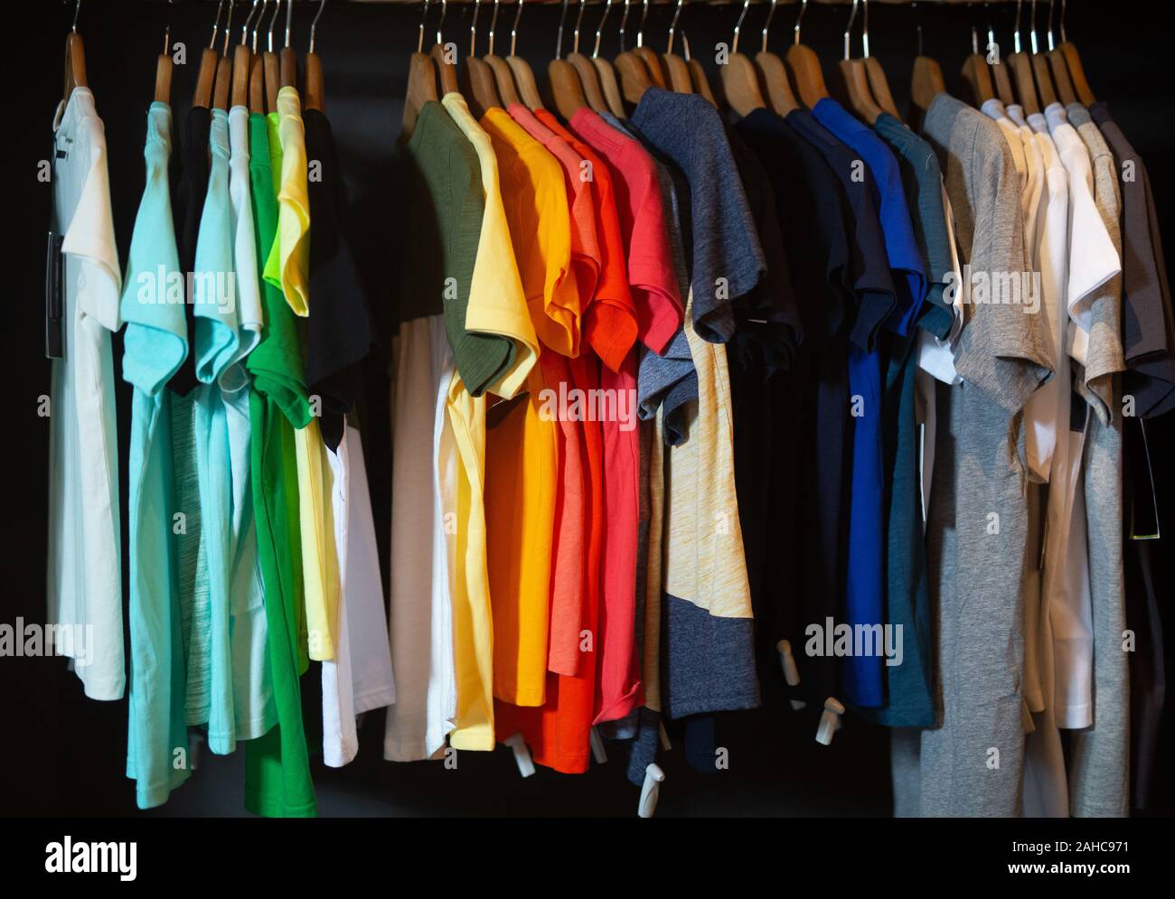 Variety of new modern assortment male wear on hangers and shelves in ...