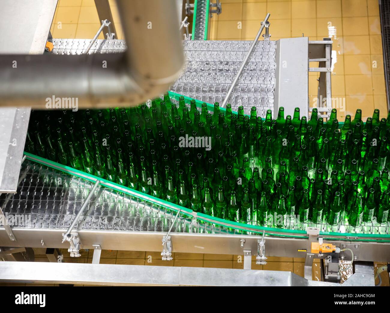 Empty green beer bottles on the conveyor belt hi-res stock photography ...