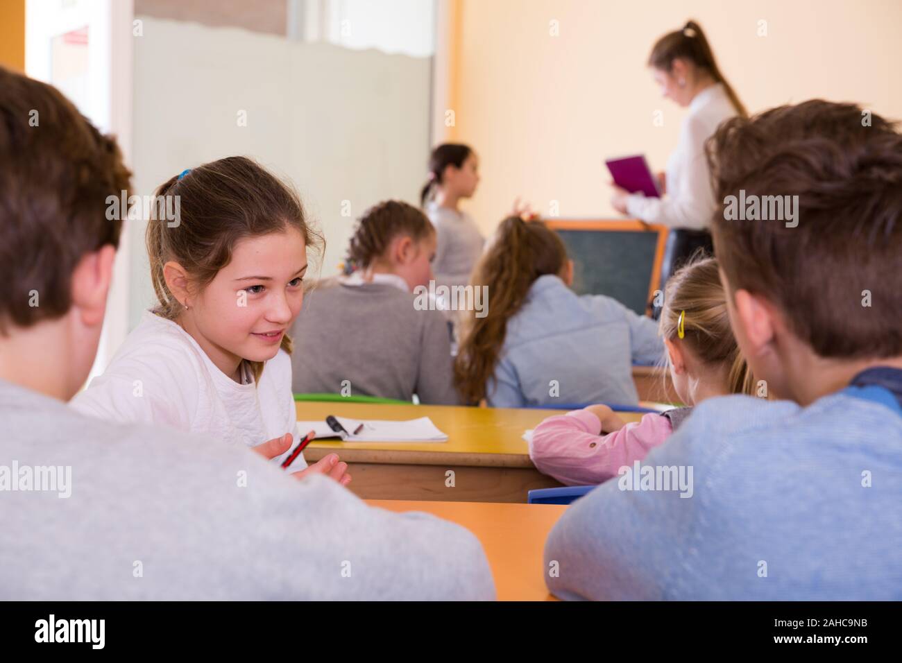 Portrait of children discussing something during lesson in school Stock ...