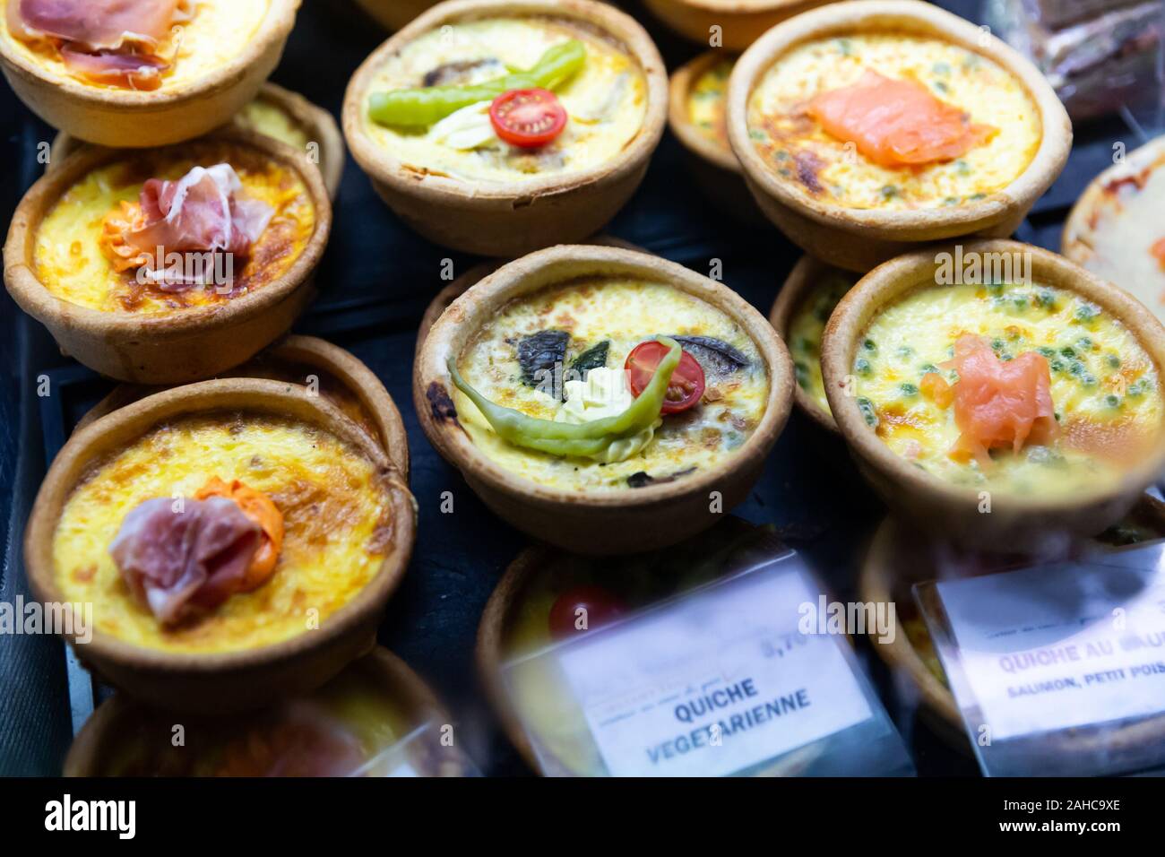 Traditional French quiches in assortment filled with egg, cheese, meat ...
