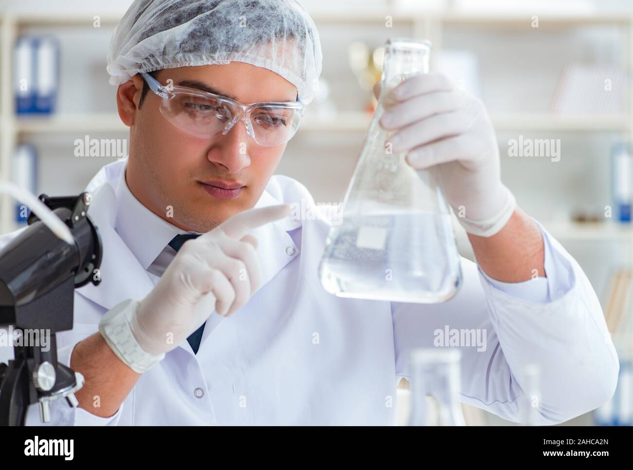 Young researcher scientist doing a water test contamination experiment ...