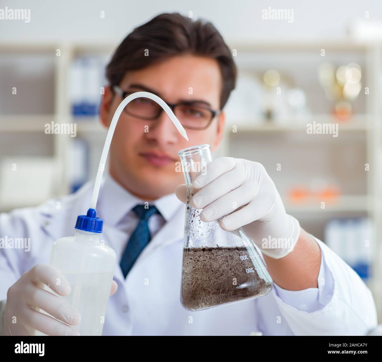 Young researcher scientist doing a water test contamination experiment ...