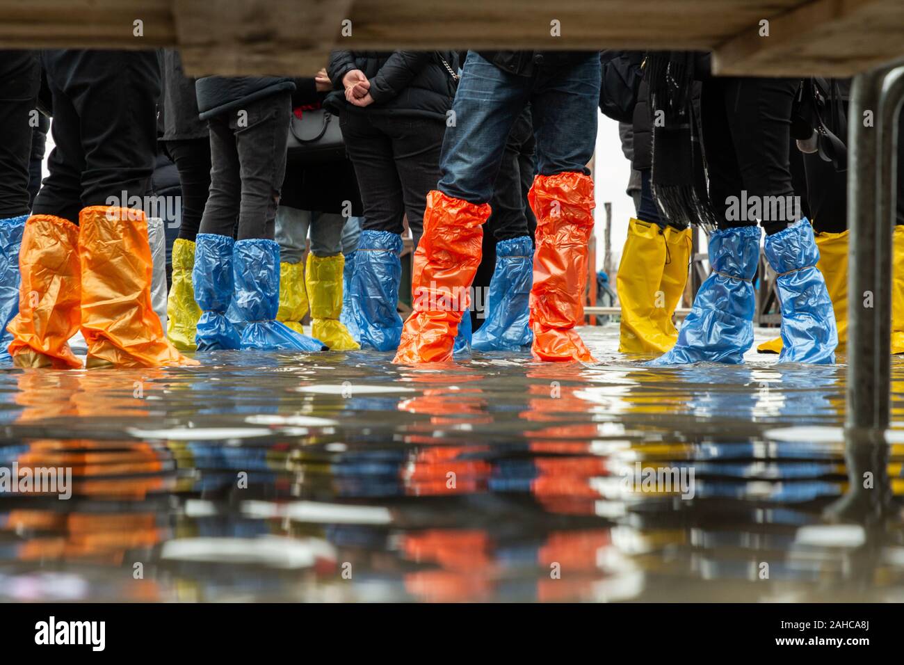 group of tourists wearing colorful disposable plastic boots Stock Photo ...