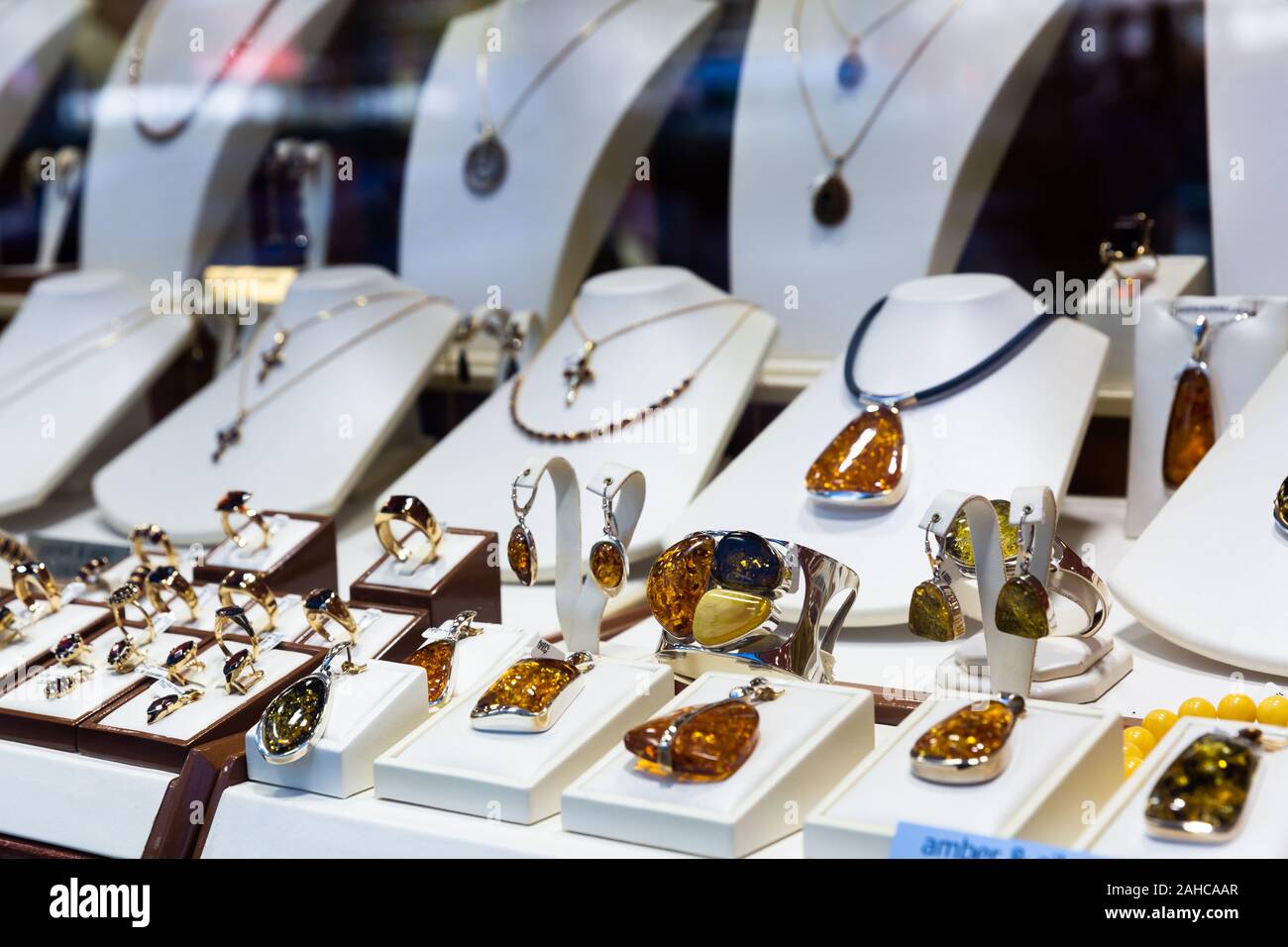 Various examples of jewelry made of amber mounted in precious metals ...