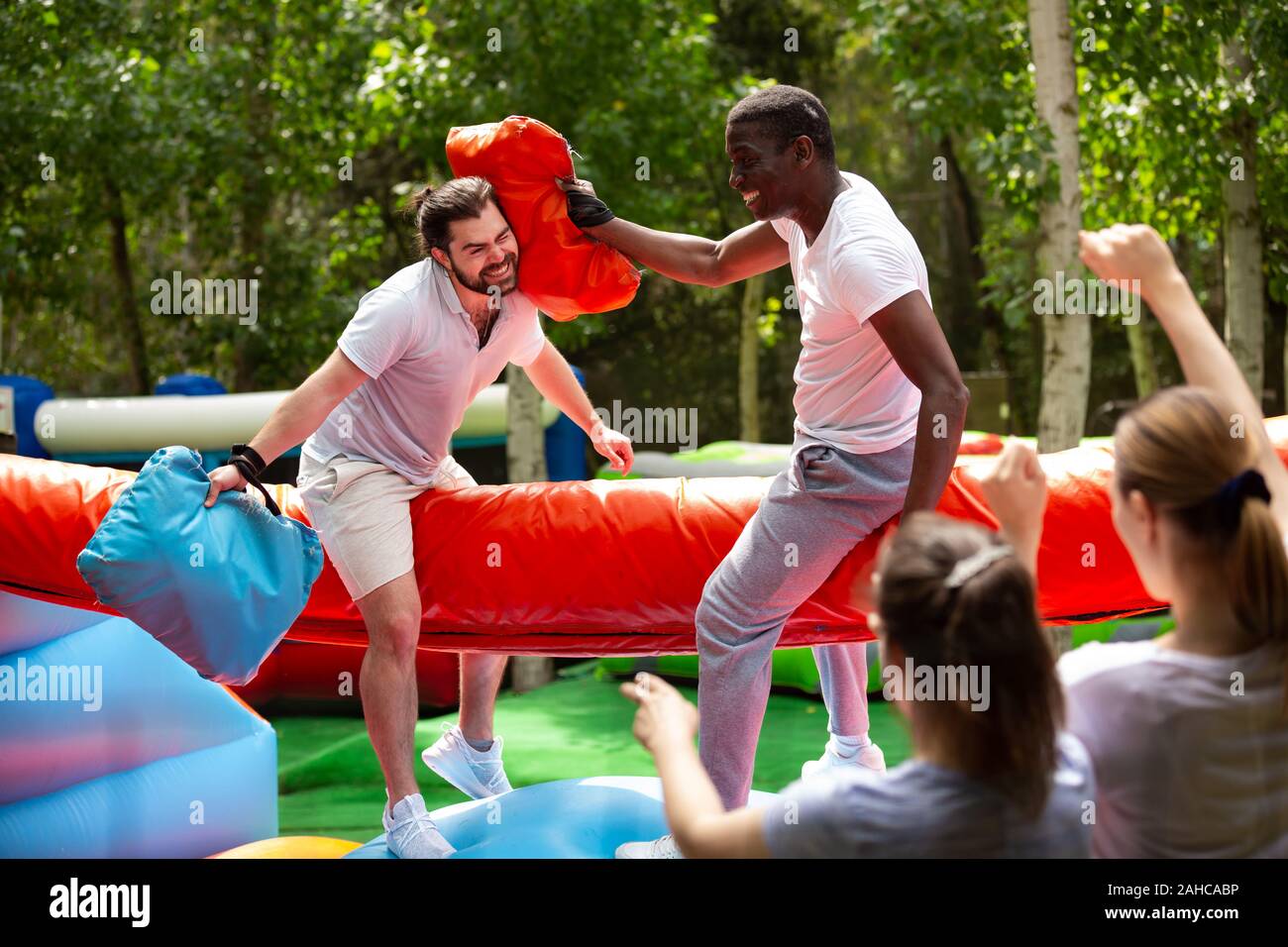 Fun wrestling with pillow in an amusement park on a summer sunny day ...