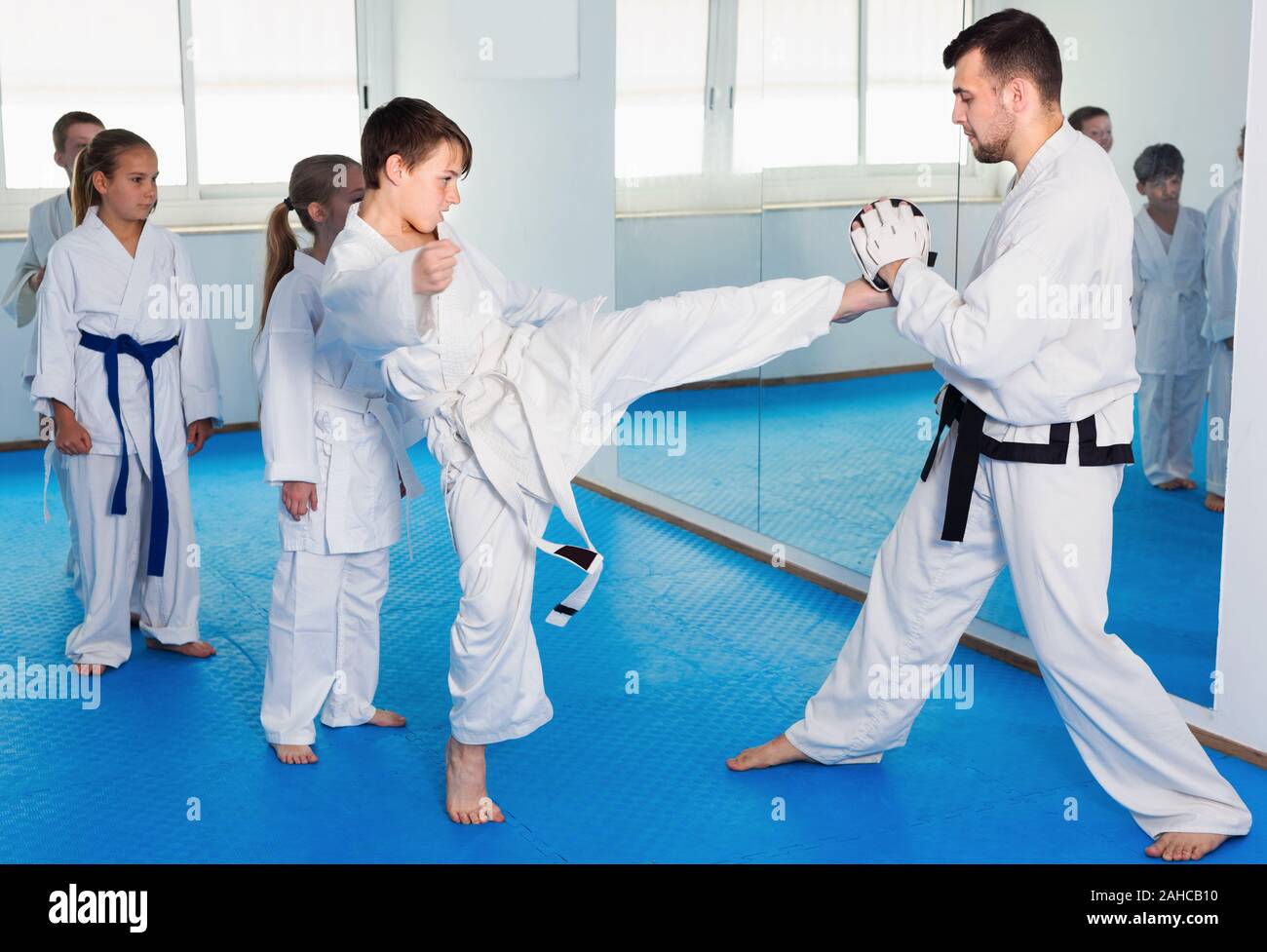 Boys trying in sparring to use new technique at karate class Stock ...