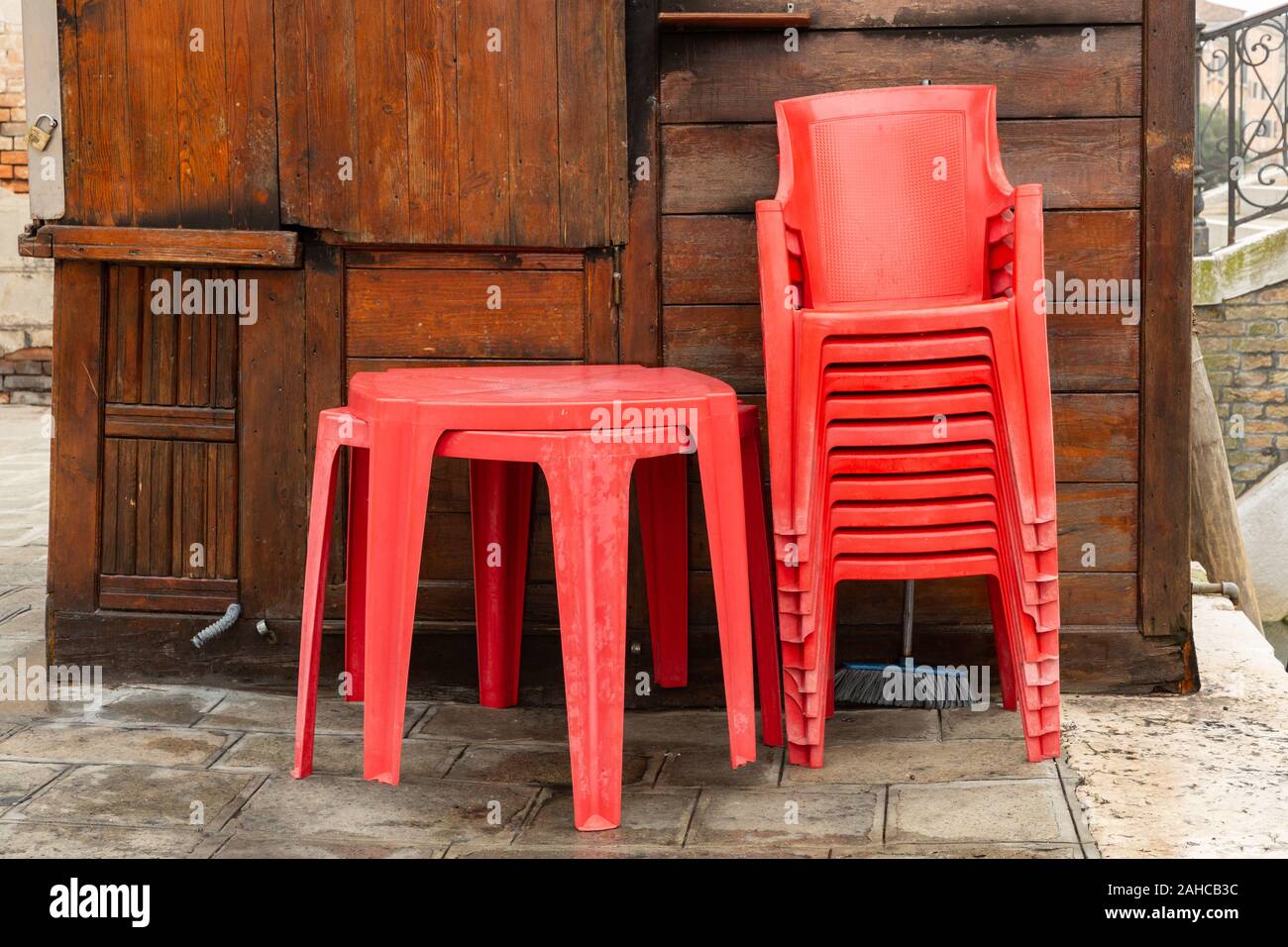 stack of red plastic chairs and tables Stock Photo - Alamy