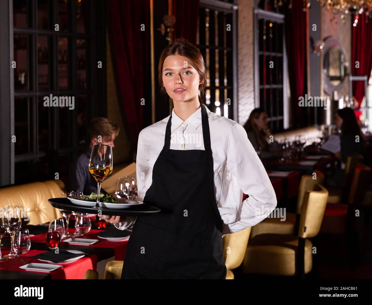 Portrait of smiling waitress with tray at luxury restaurant Stock Photo ...